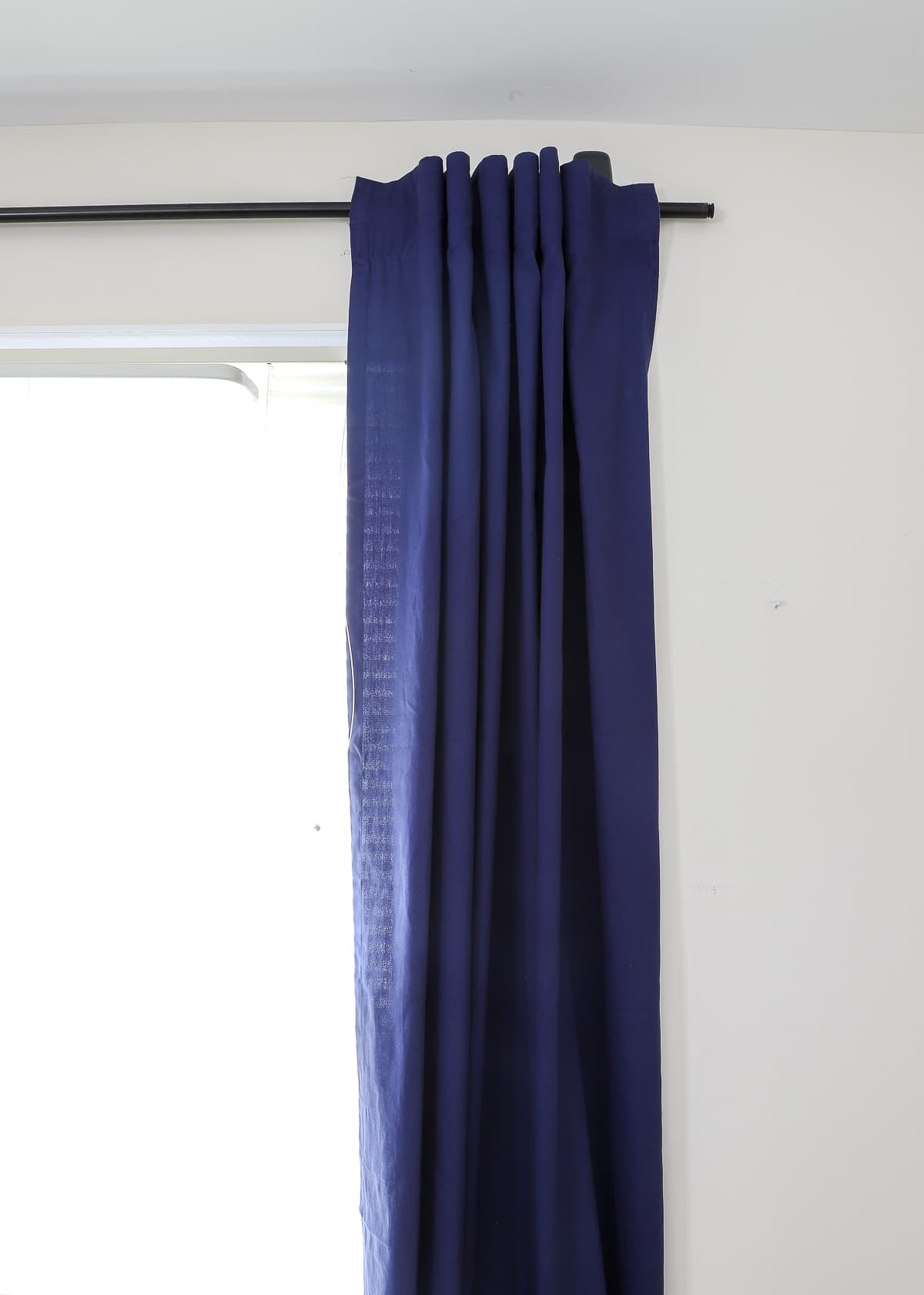 How to Hang a Curtain Rod Without Drilling into the Wall